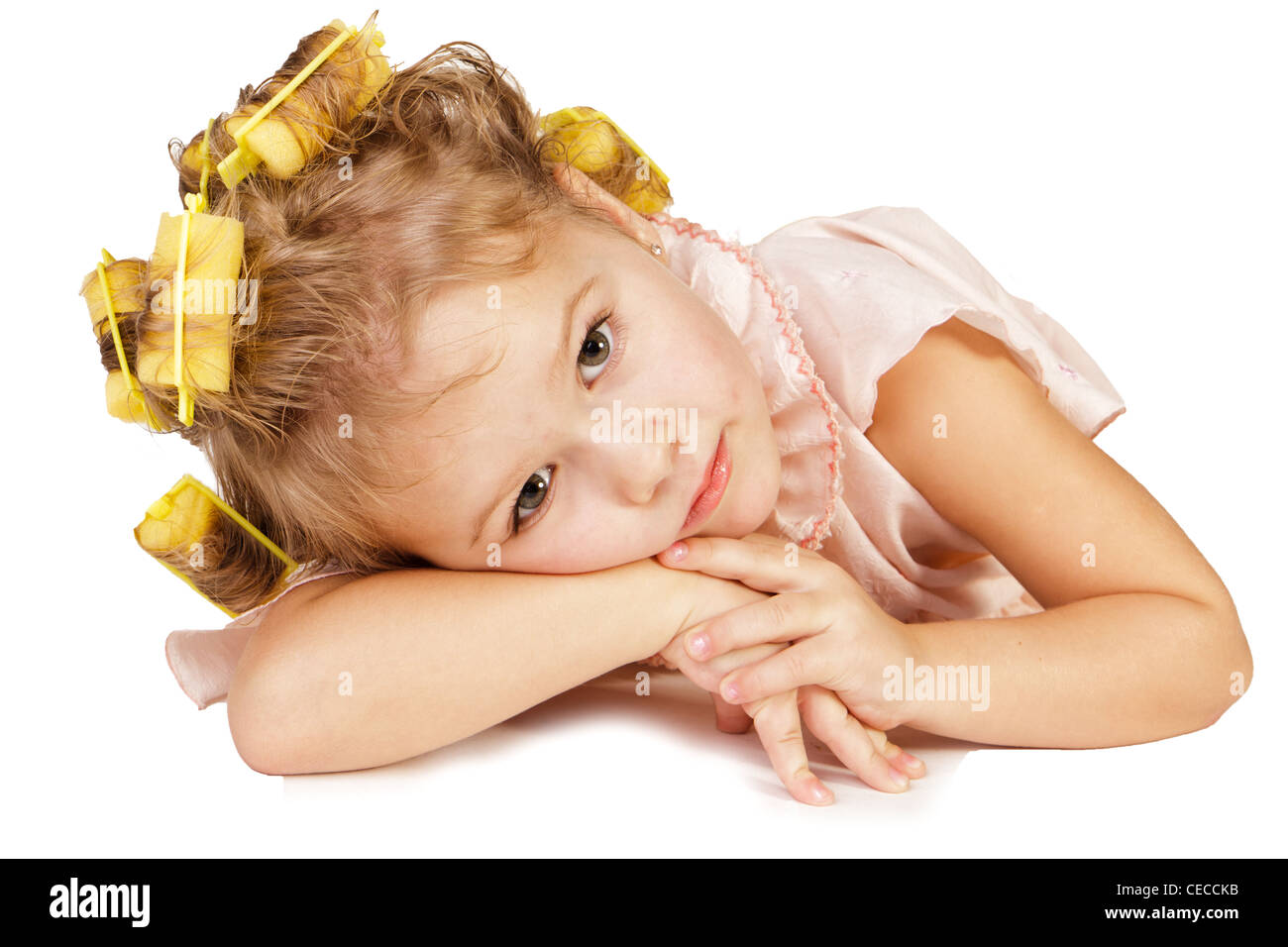 Beautiful little girl in rollers over white background Stock Photo - Alamy