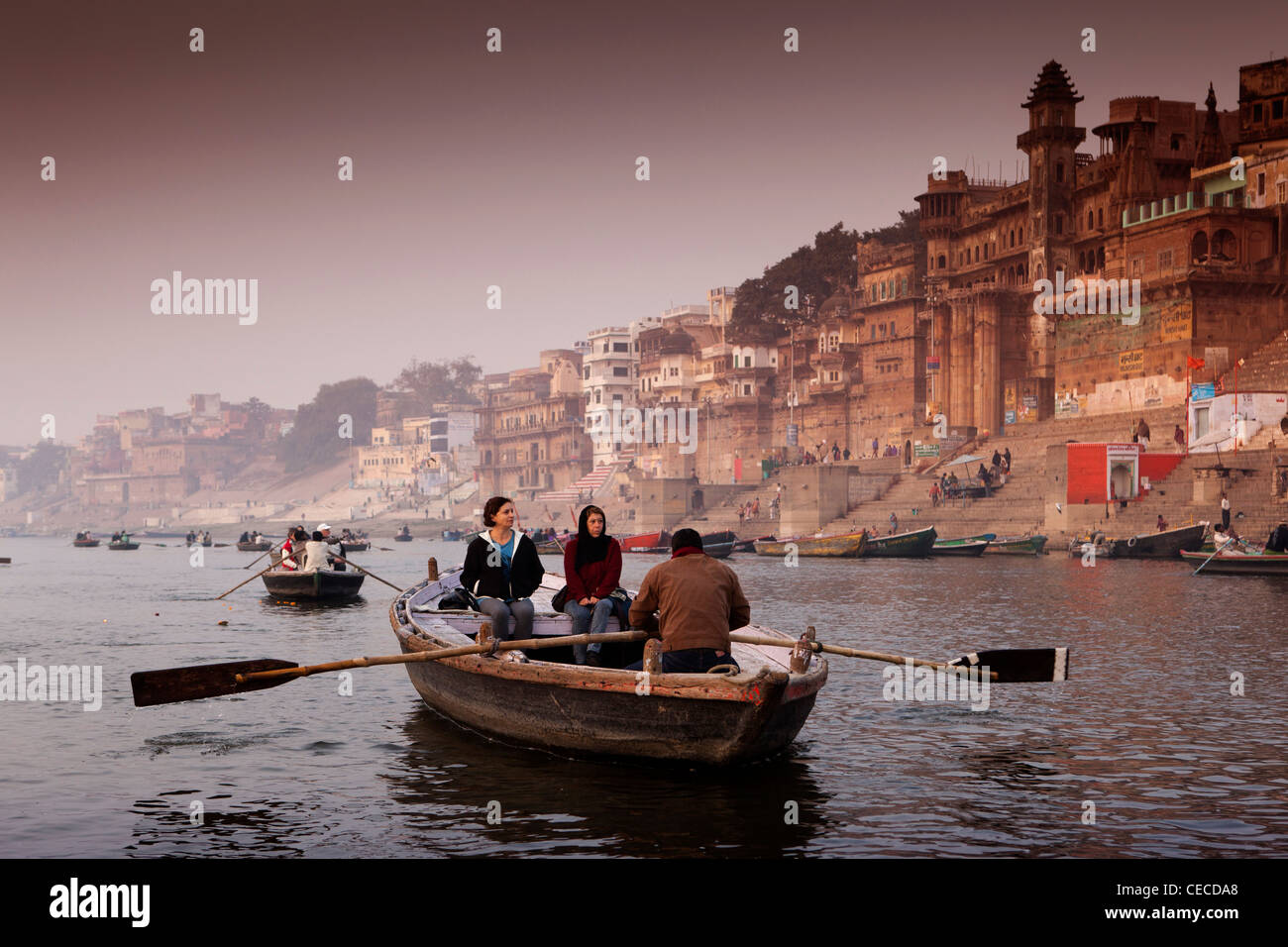 India, Uttar Pradesh, Varanasi, Munshi Ghat, tourists enjoying dawn ...