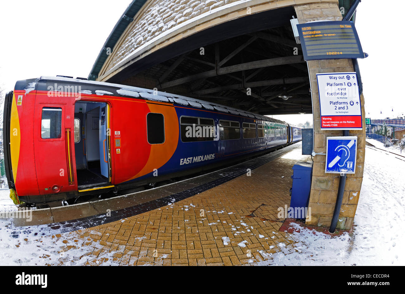 Commuter train pulling out of the local train station after a snow fall ...