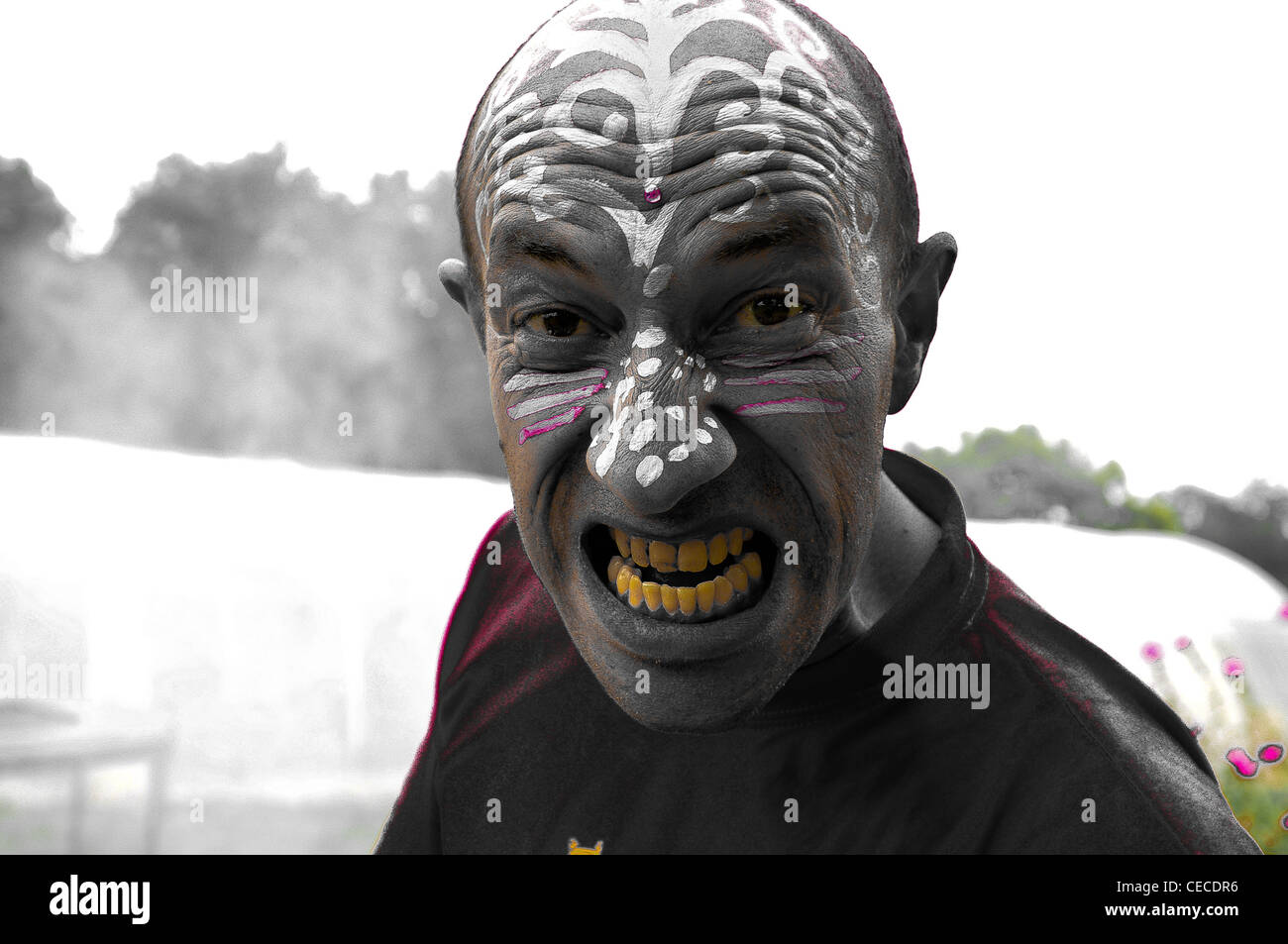 angry man wearing face paint snarls at camera Stock Photo - Alamy