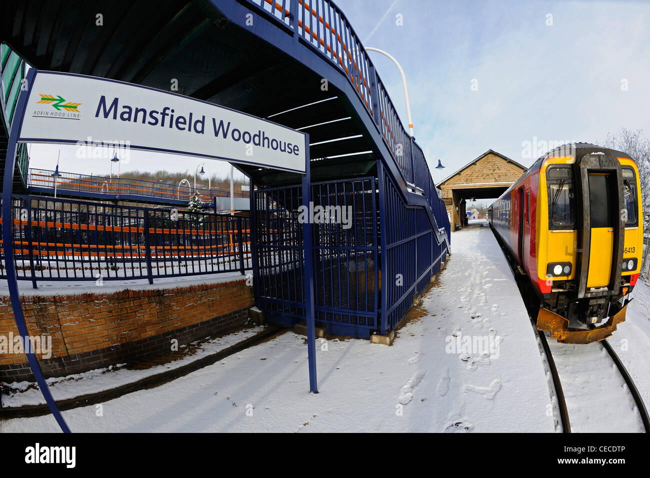 Commuter train pulling out of the local train station after a snow fall ...