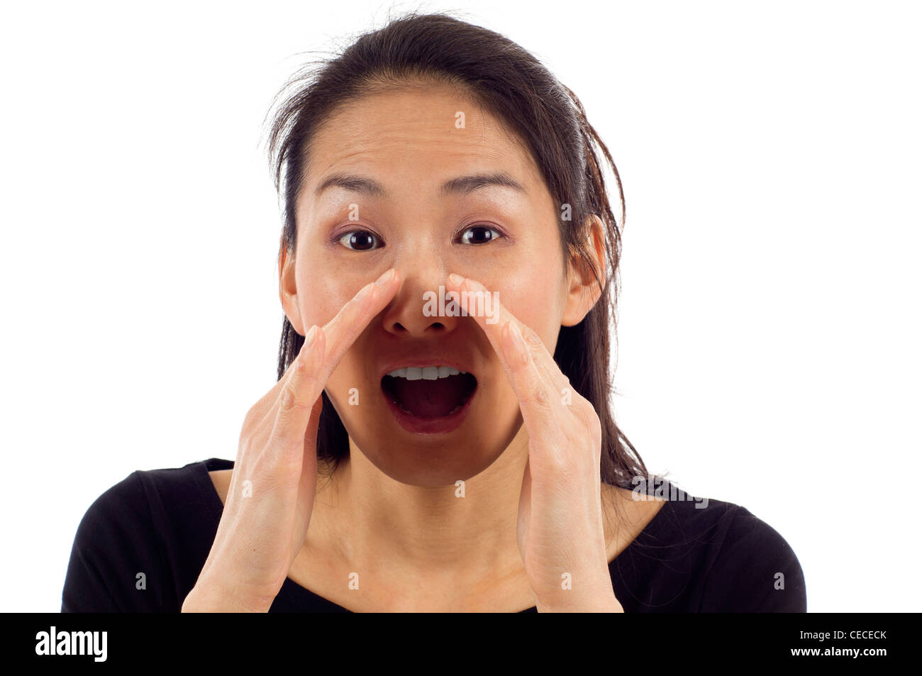 Young Asian woman loud screaming or calling out to someone isolated ...