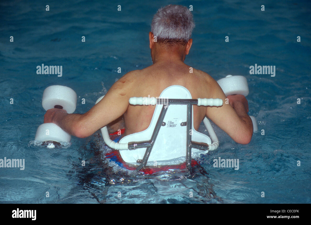 Disabled man exercising in swimming pool, Peckham Pulse, Southwark ...
