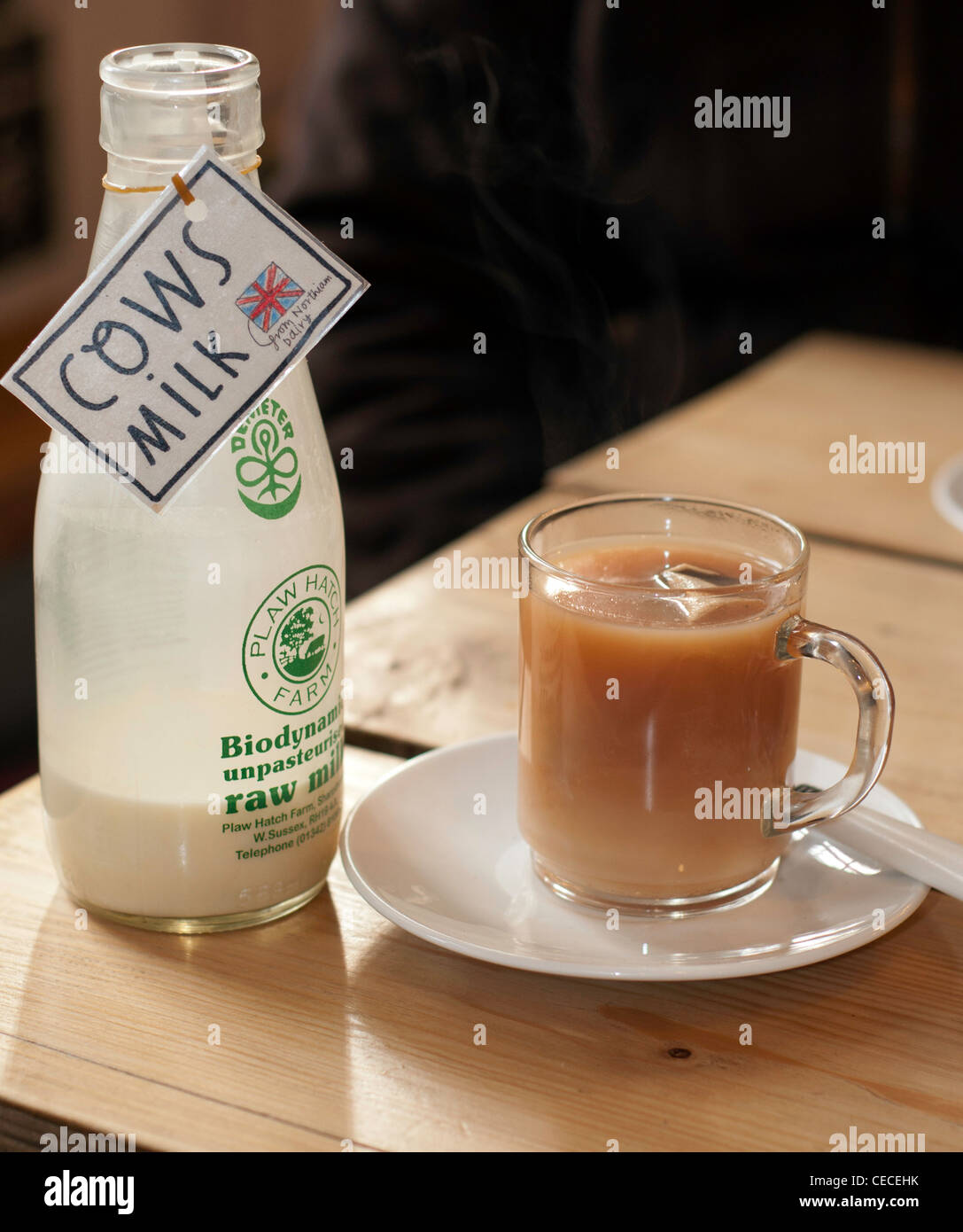Bottle of cows milk with cup of tea Stock Photo - Alamy