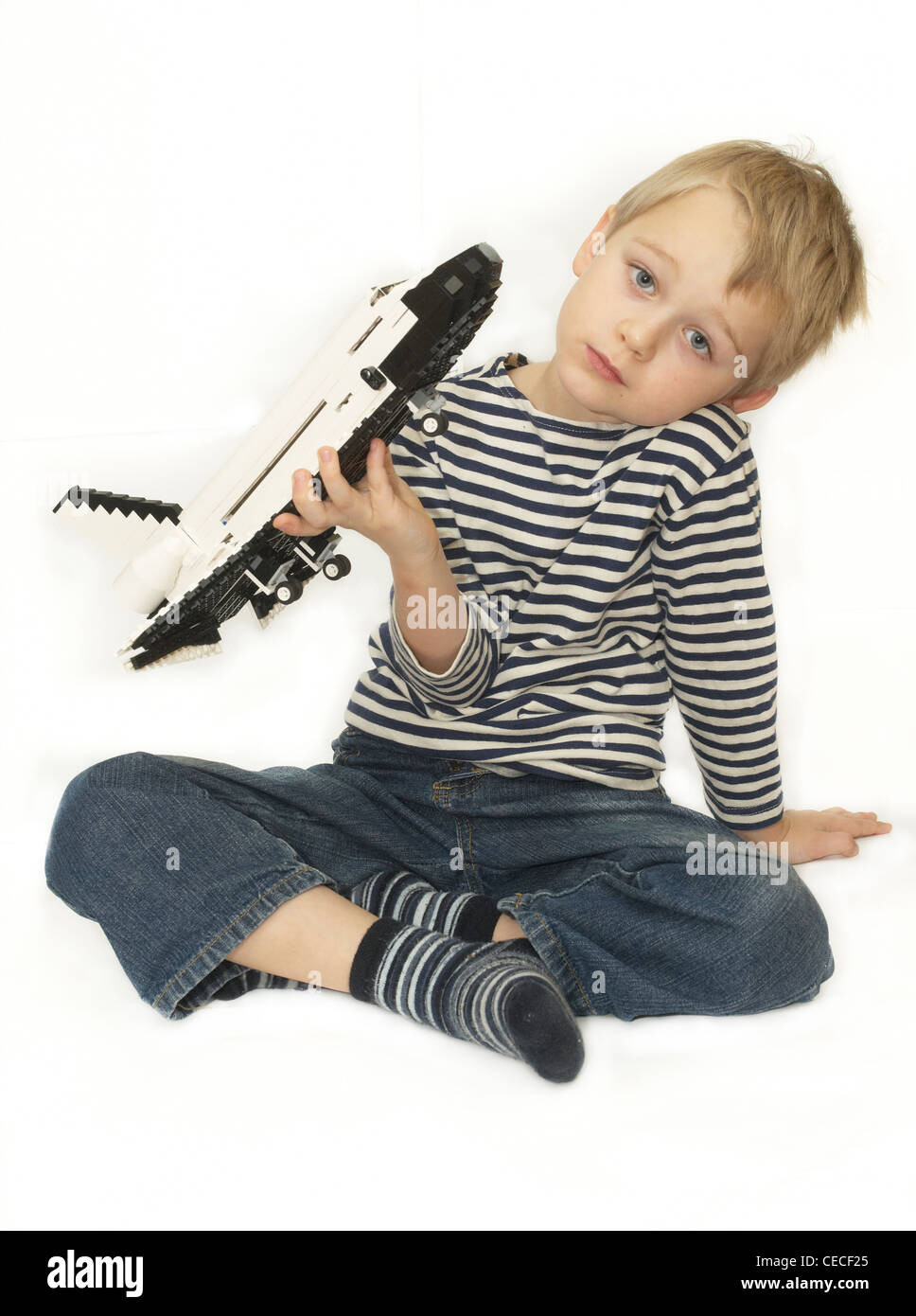 Child blond boy playing with Lego Space Shuttle model toy cut out Stock ...