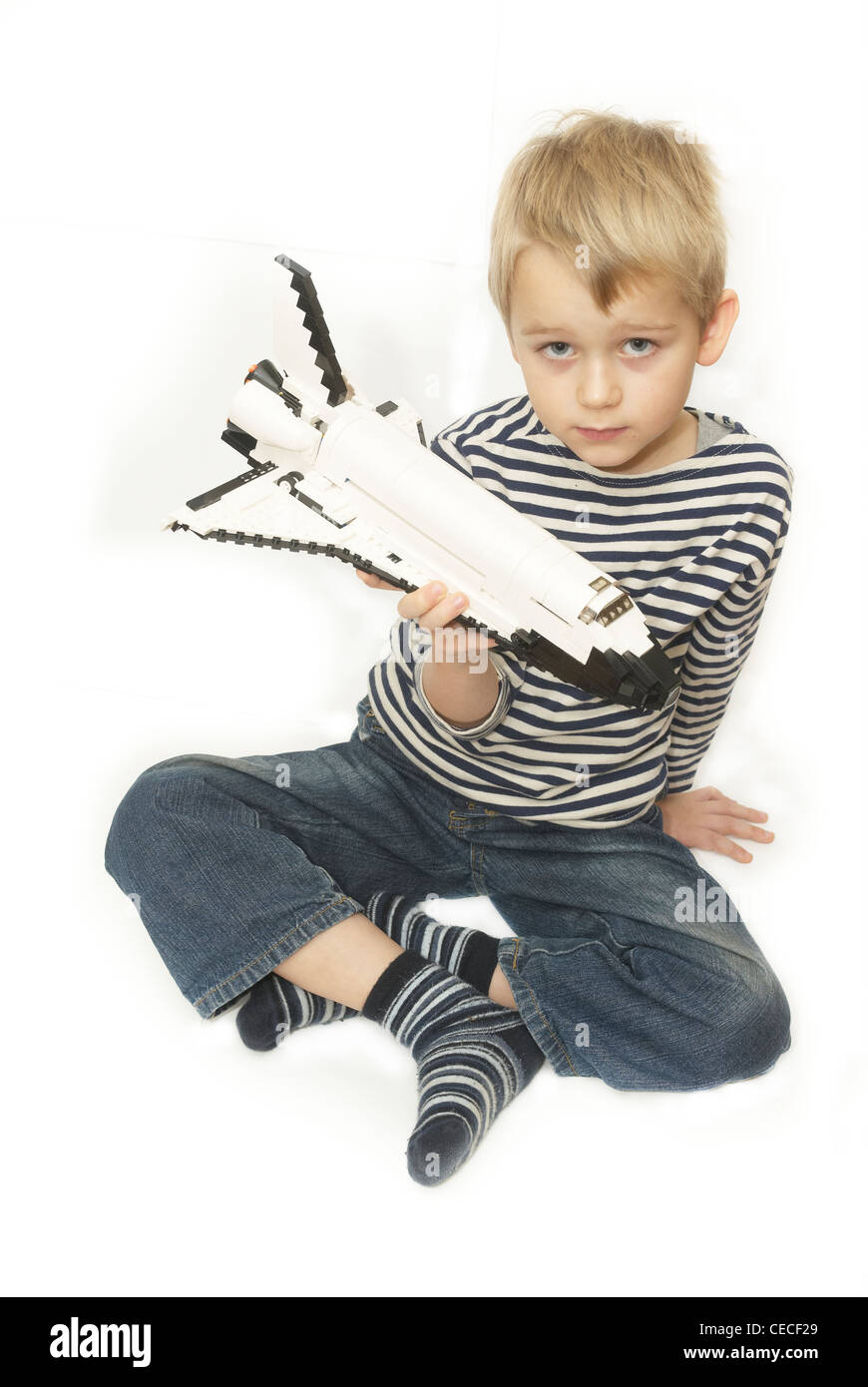 Child blond boy playing with Lego Space Shuttle model toy cut out Stock ...