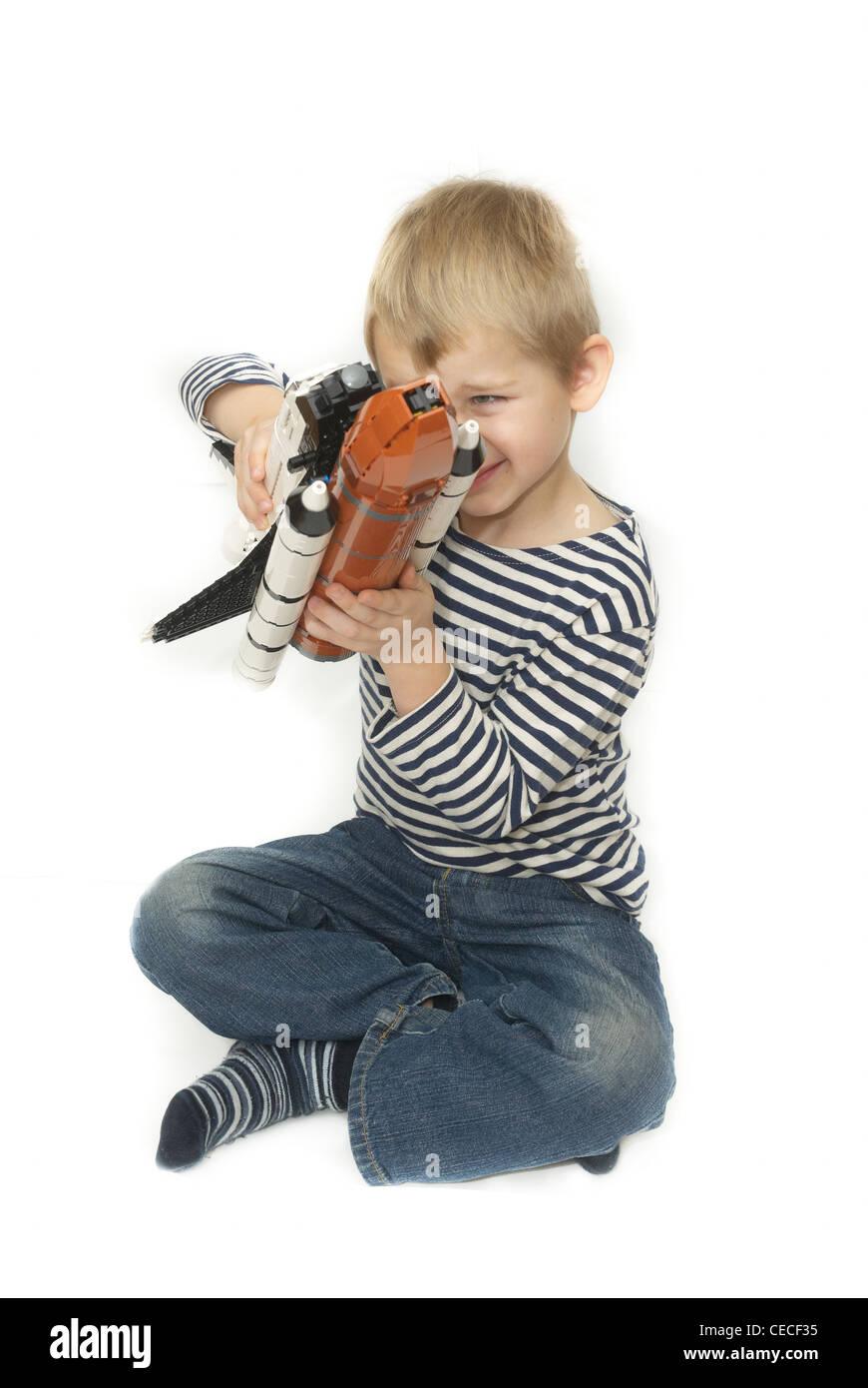 Child blond boy playing with Lego Space Shuttle model toy cut out Stock ...
