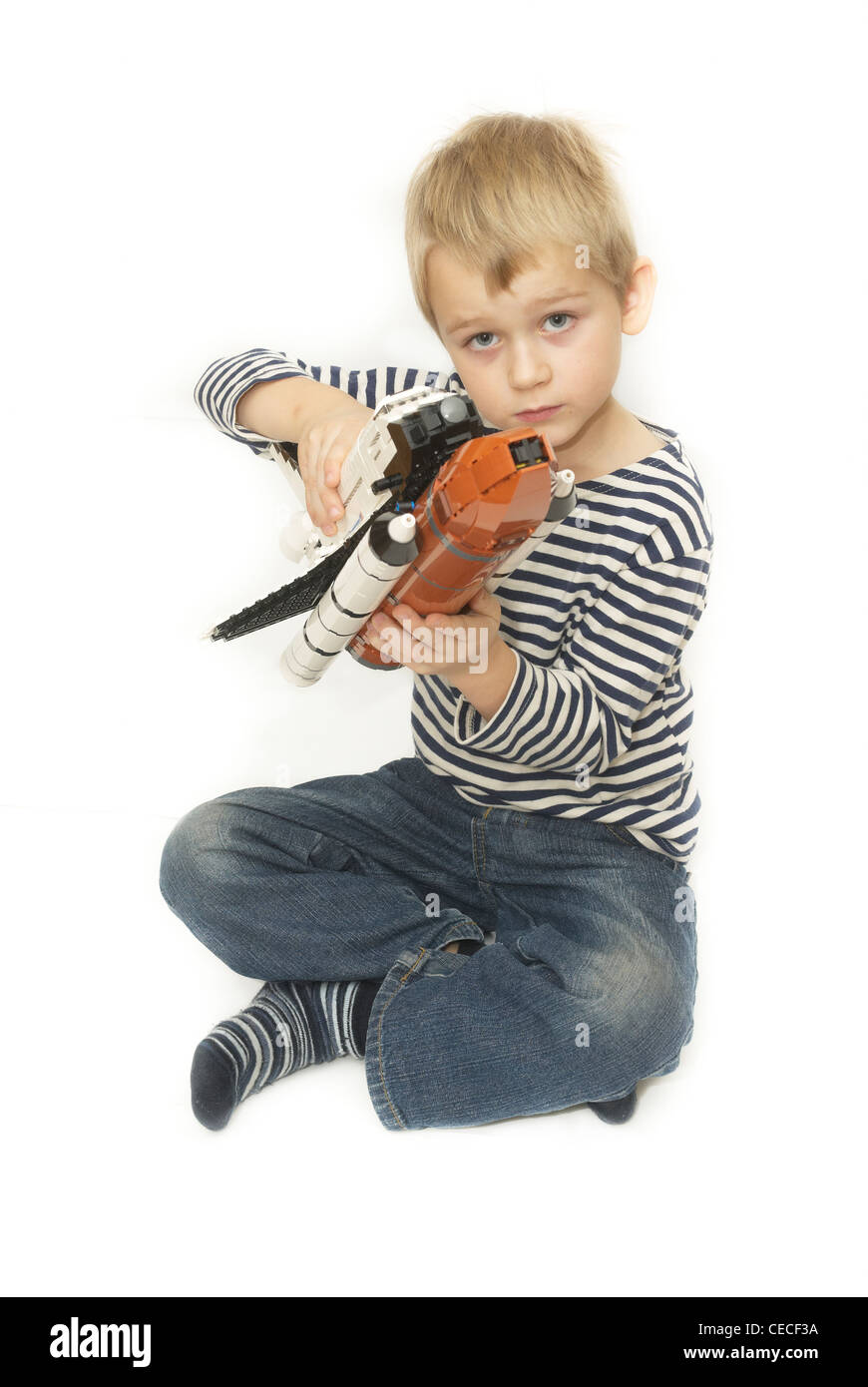 Child blond boy playing with Lego Space Shuttle model toy cut out Stock ...