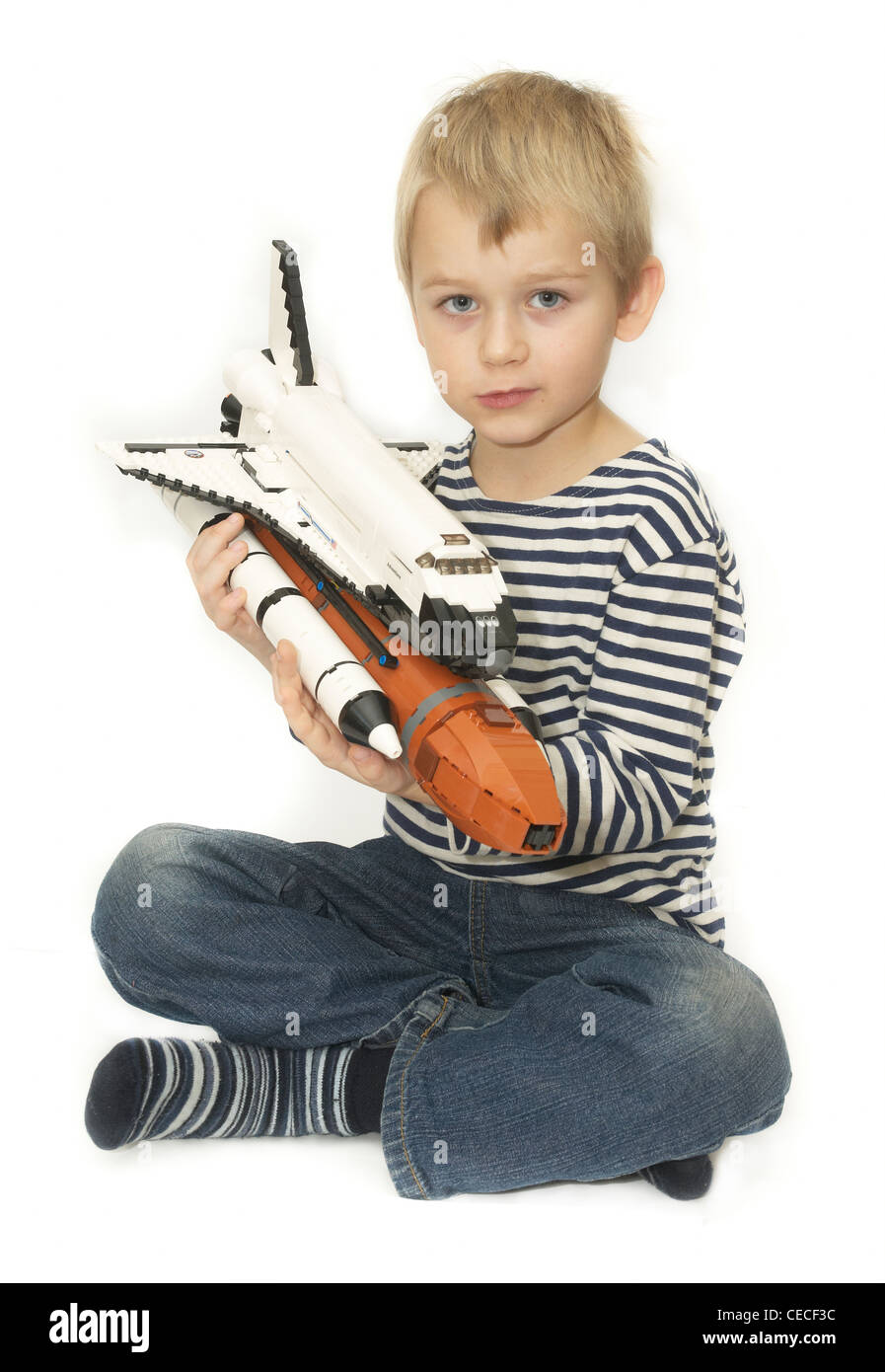 Child blond boy playing with Lego Space Shuttle model toy cut out Stock ...