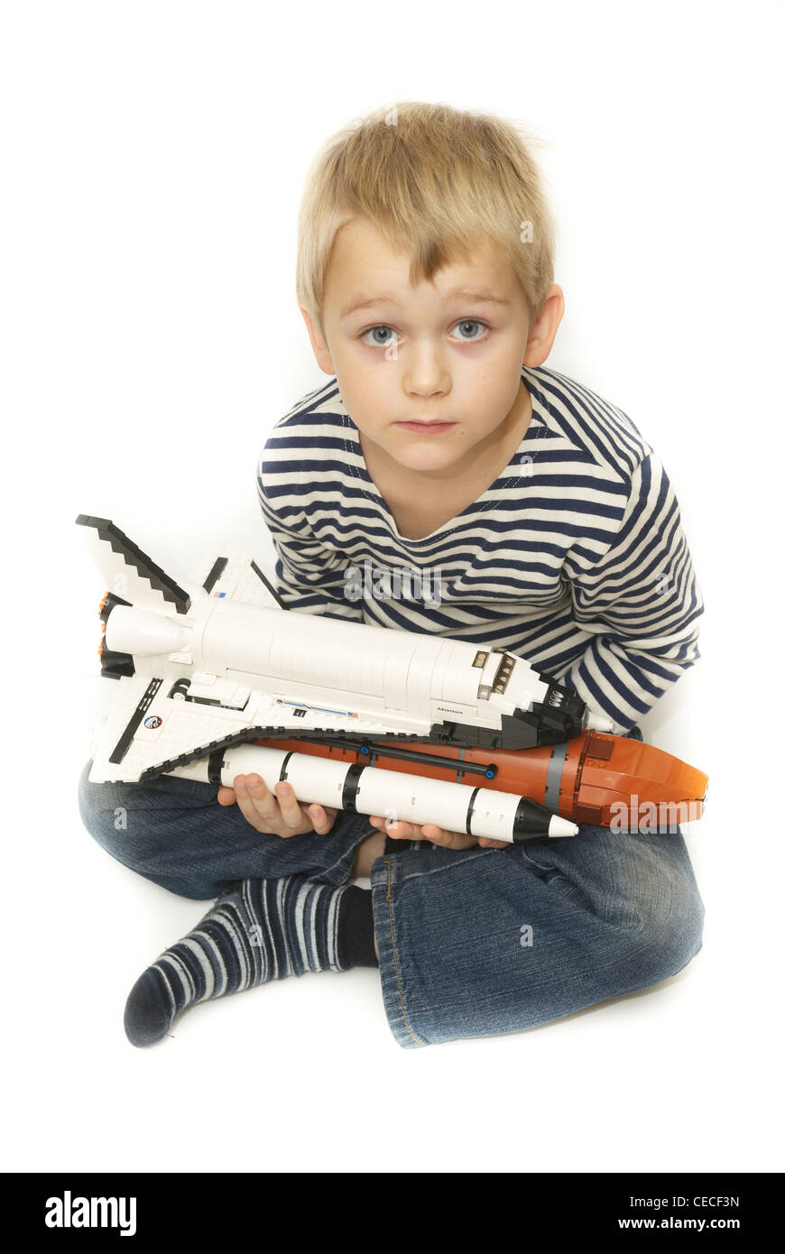 Child blond boy playing with Lego Space Shuttle model toy cut out Stock ...