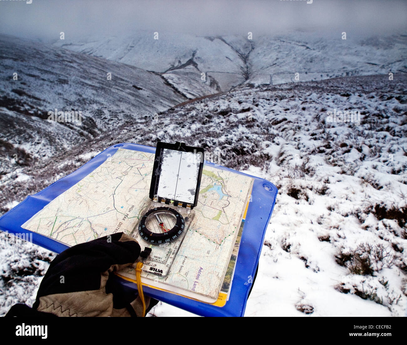 Map and compass work on winter walk, Kinder Scout, Peak District ...