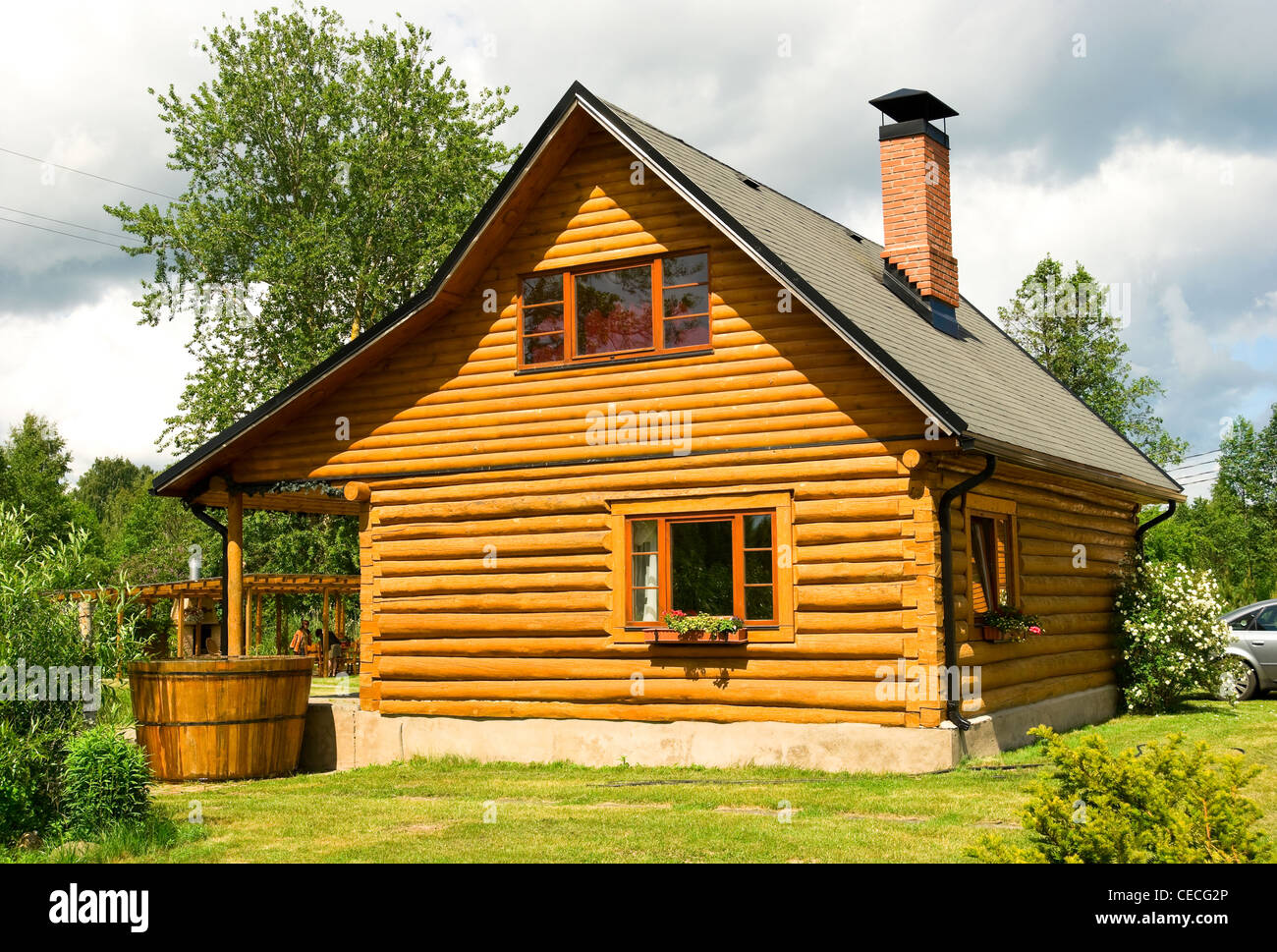 Wooden house for rest with a sauna and the big wooden font Stock Photo ...