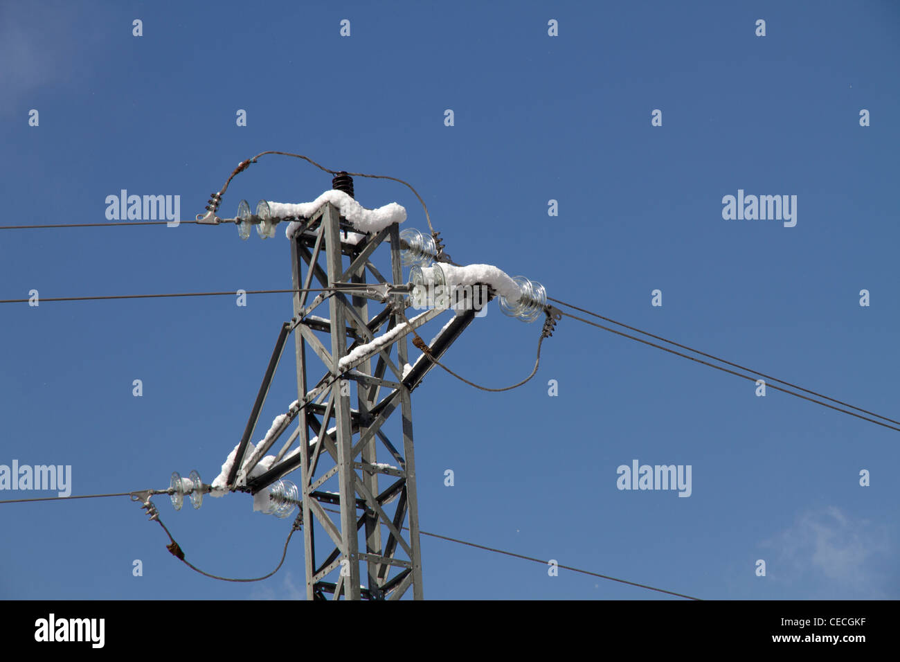 power electricity lines snow in blue sky winter Stock Photo - Alamy