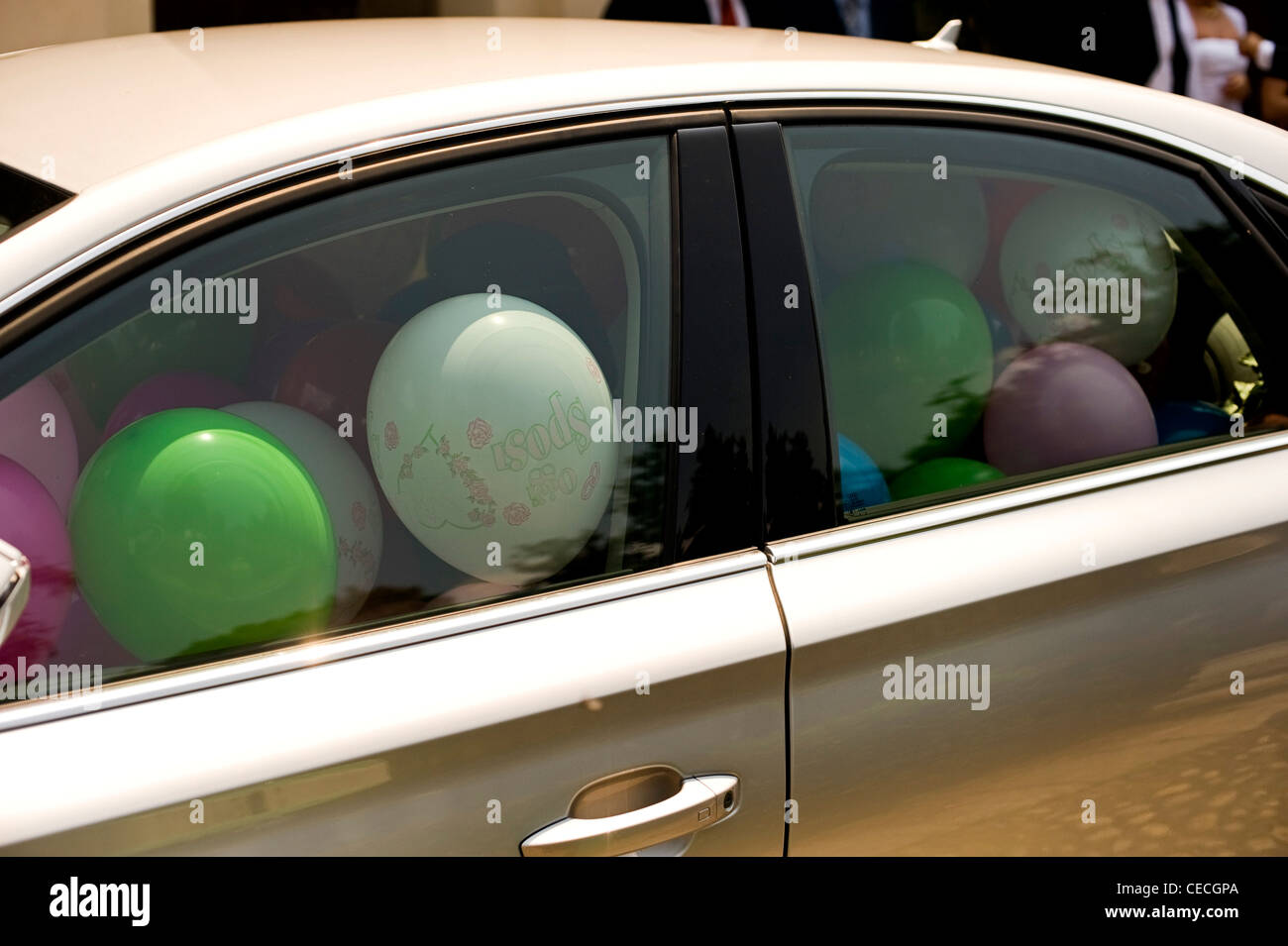 newlyweds car filled up with balloons Stock Photo - Alamy