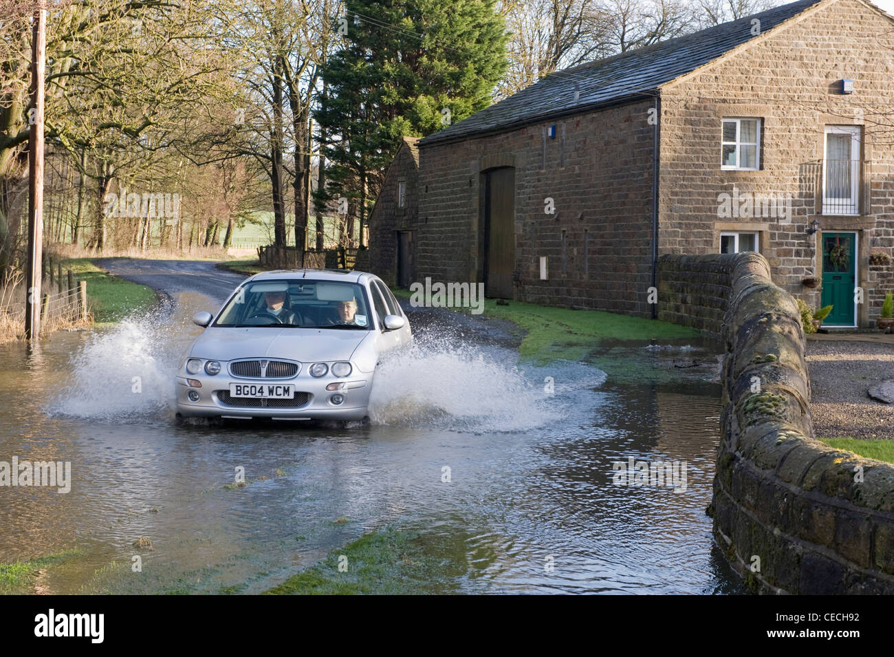 Flooding - silver car (Rover) driving & splashing through deep flood ...