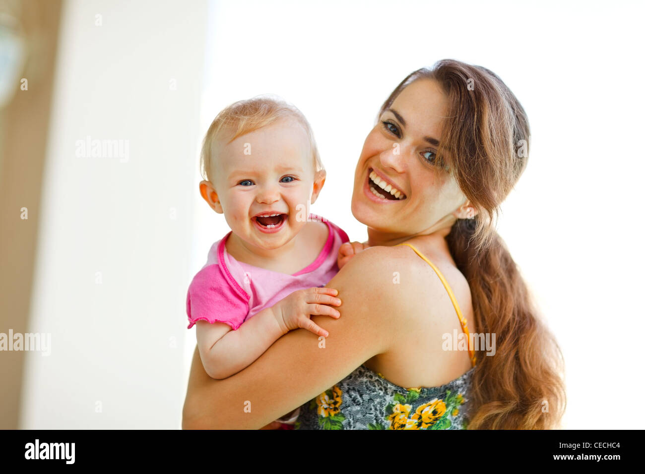 Portrait of laughing mother and baby Stock Photo - Alamy