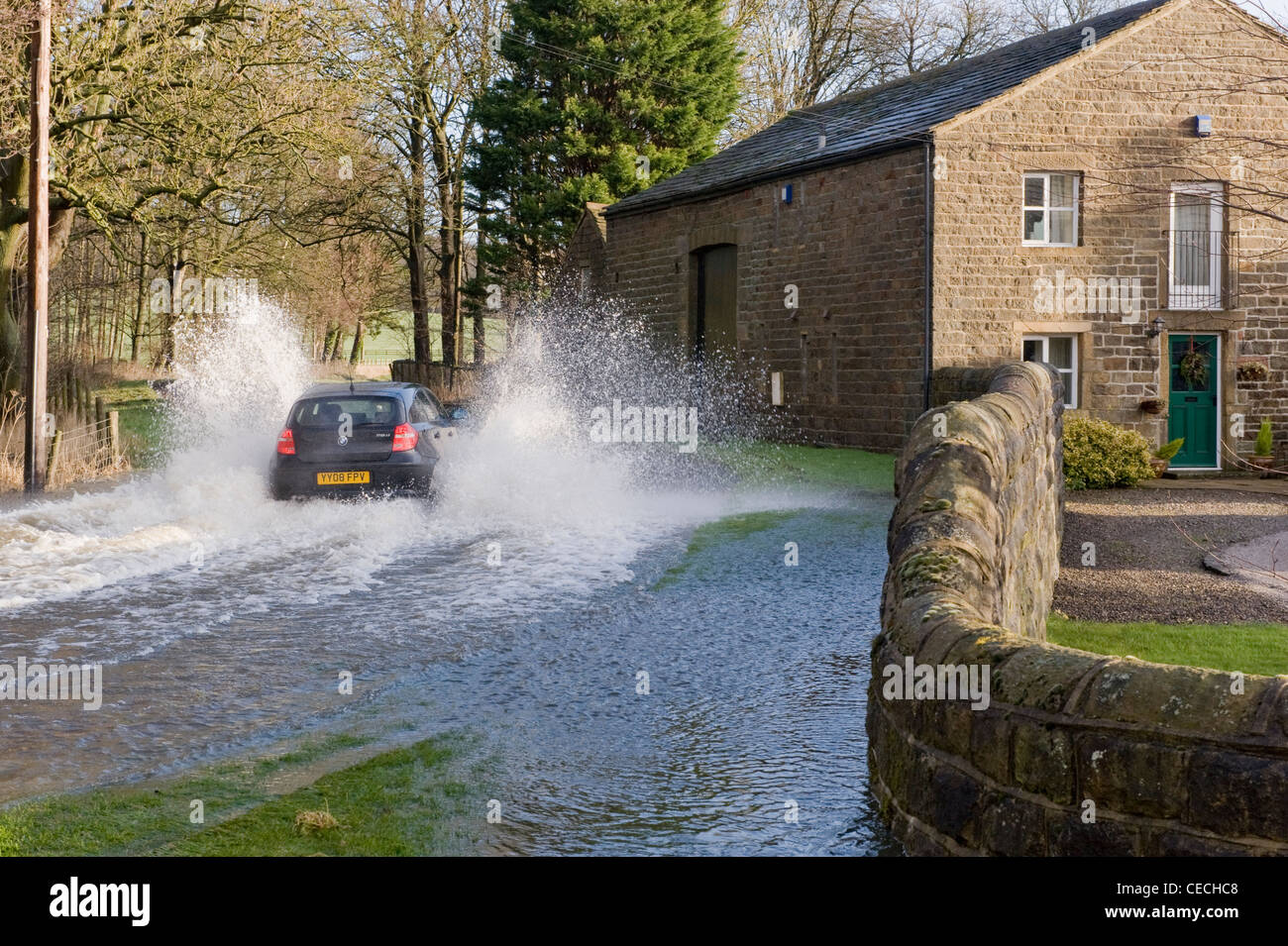 Flooding - black car (BMW) driving & splashing through deep flood water ...
