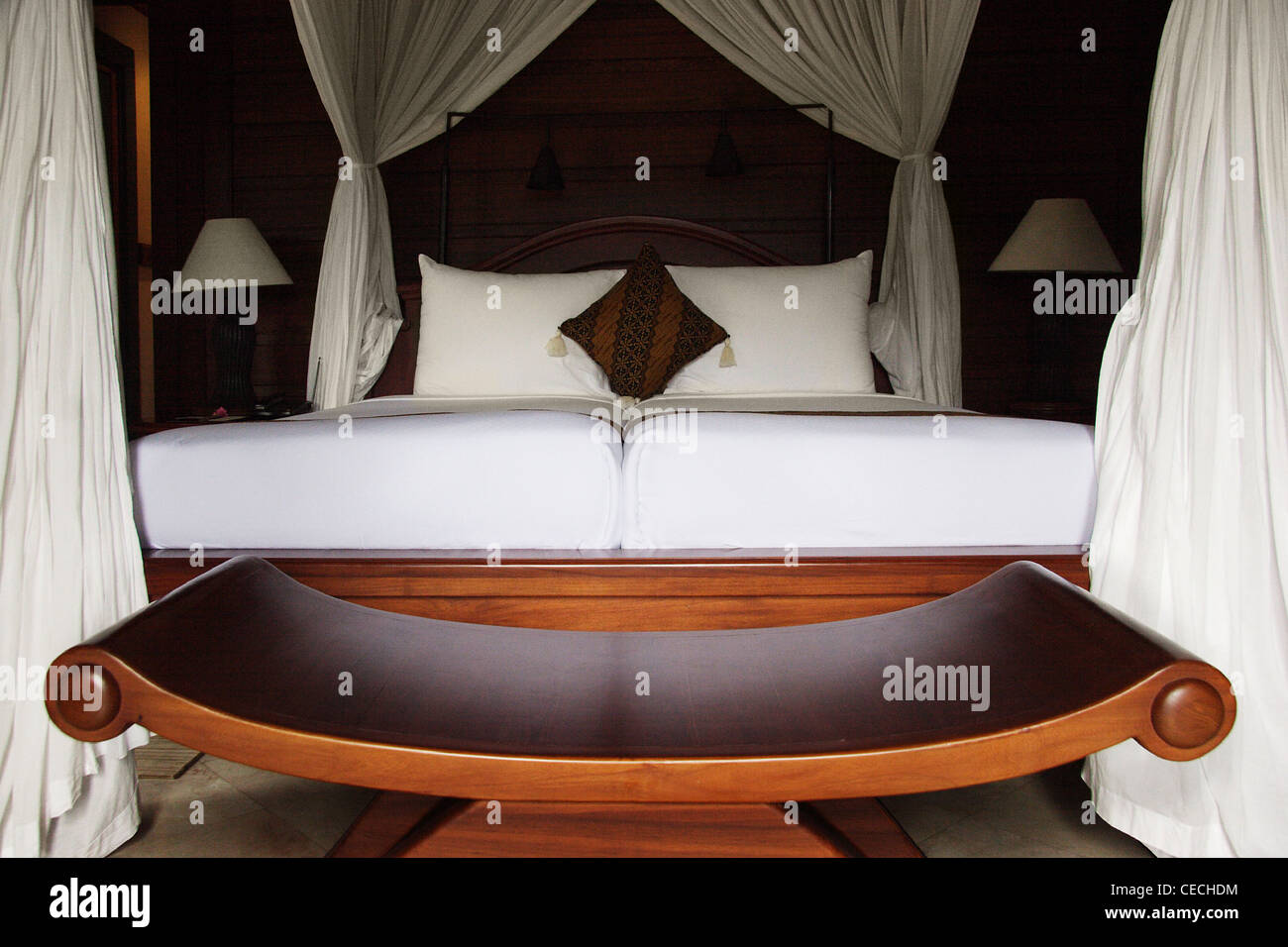 Color photograph of a bed in an upscale home in Bali with simple design ...