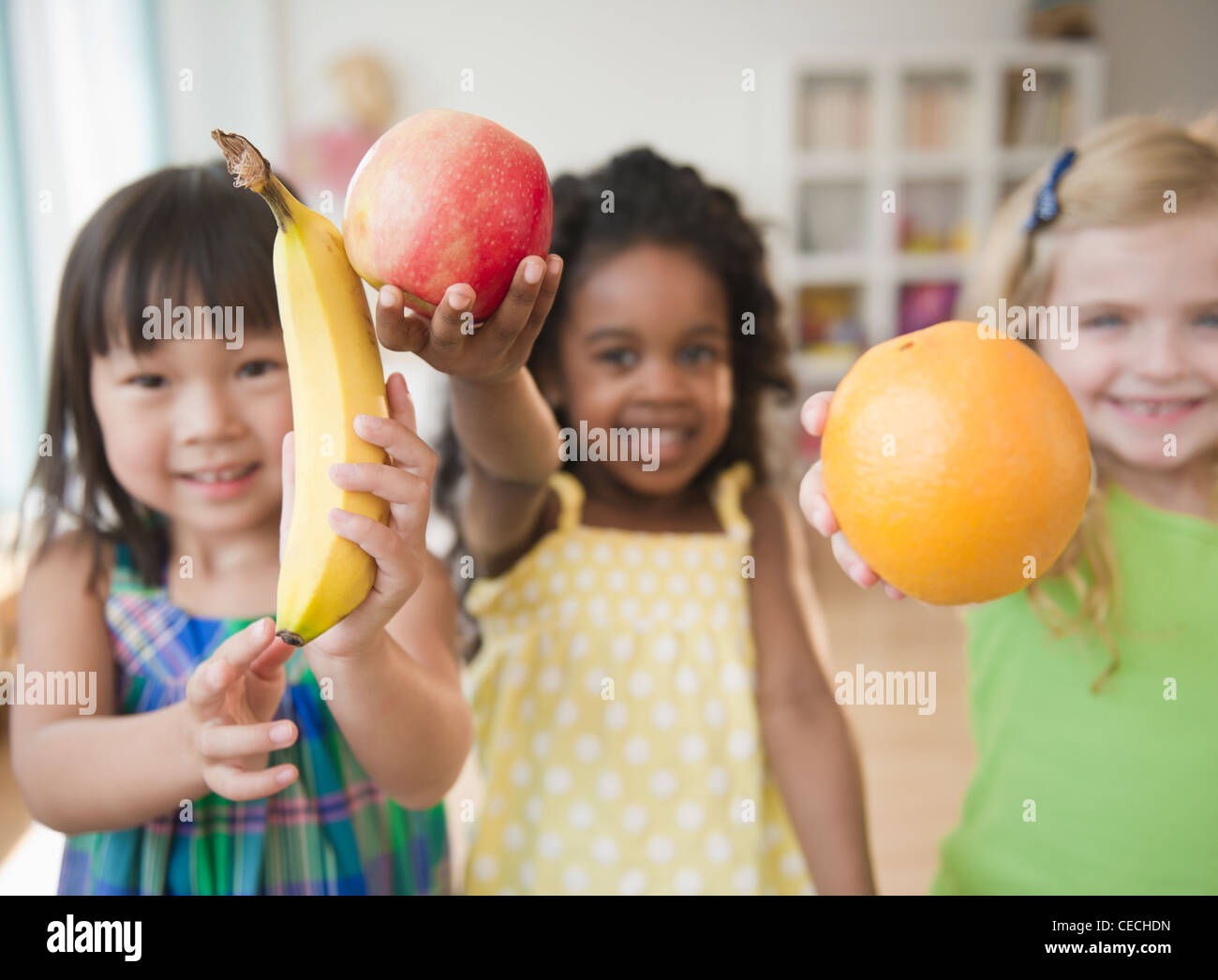 Children holding out fresh fruit Stock Photo - Alamy