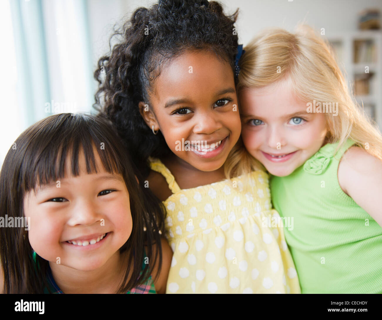 Smiling girls hugging each other Stock Photo - Alamy