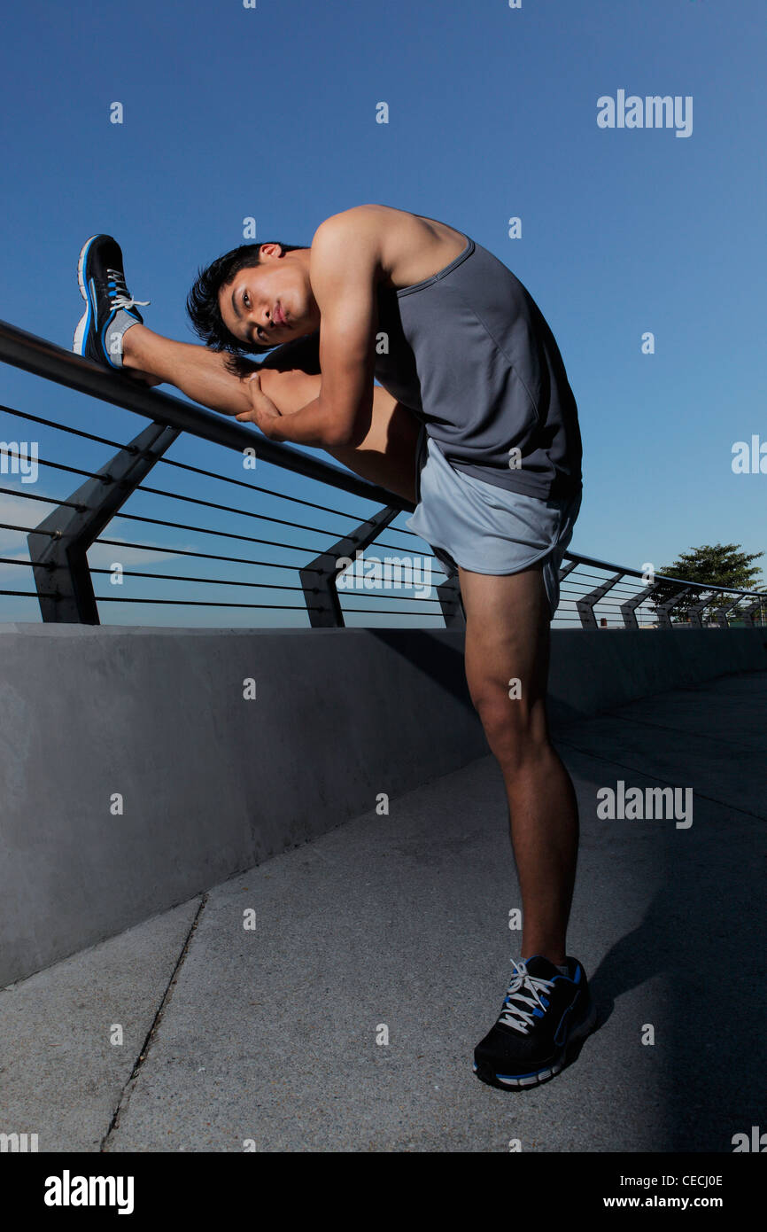 Young man standing one leg hi-res stock photography and images - Alamy