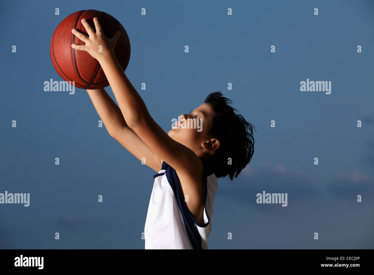Young boy catching basket ball Stock Photo - Alamy