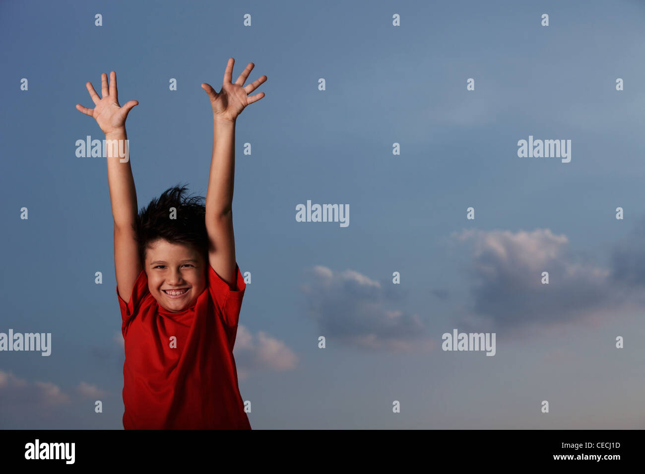young boy with red shirt smiling with hands outstretched Stock Photo ...