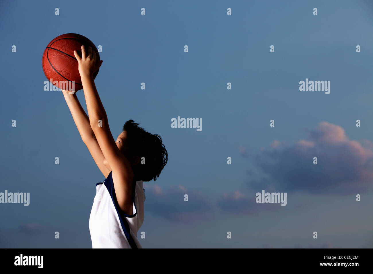 profile shot of young boy catching basketball Stock Photo - Alamy