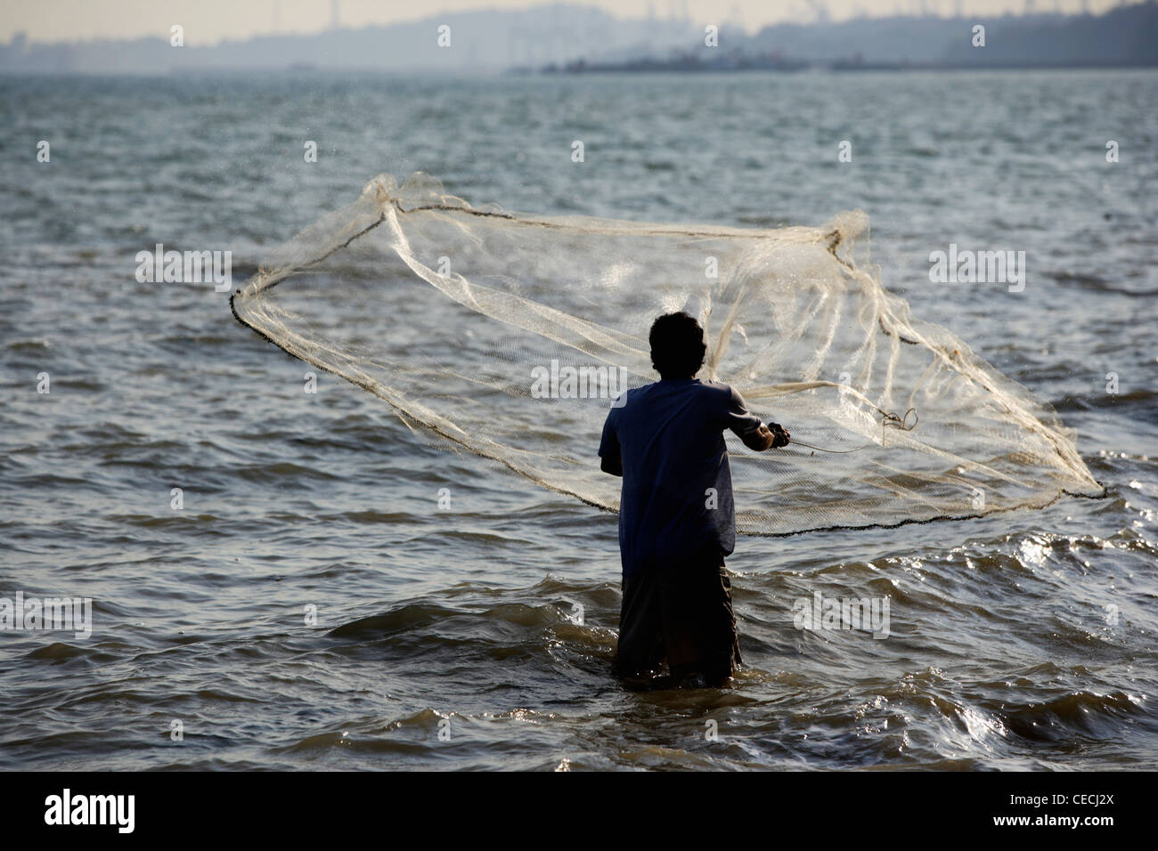 Man throwing net into the sea, Thailand Stock Photo - Alamy
