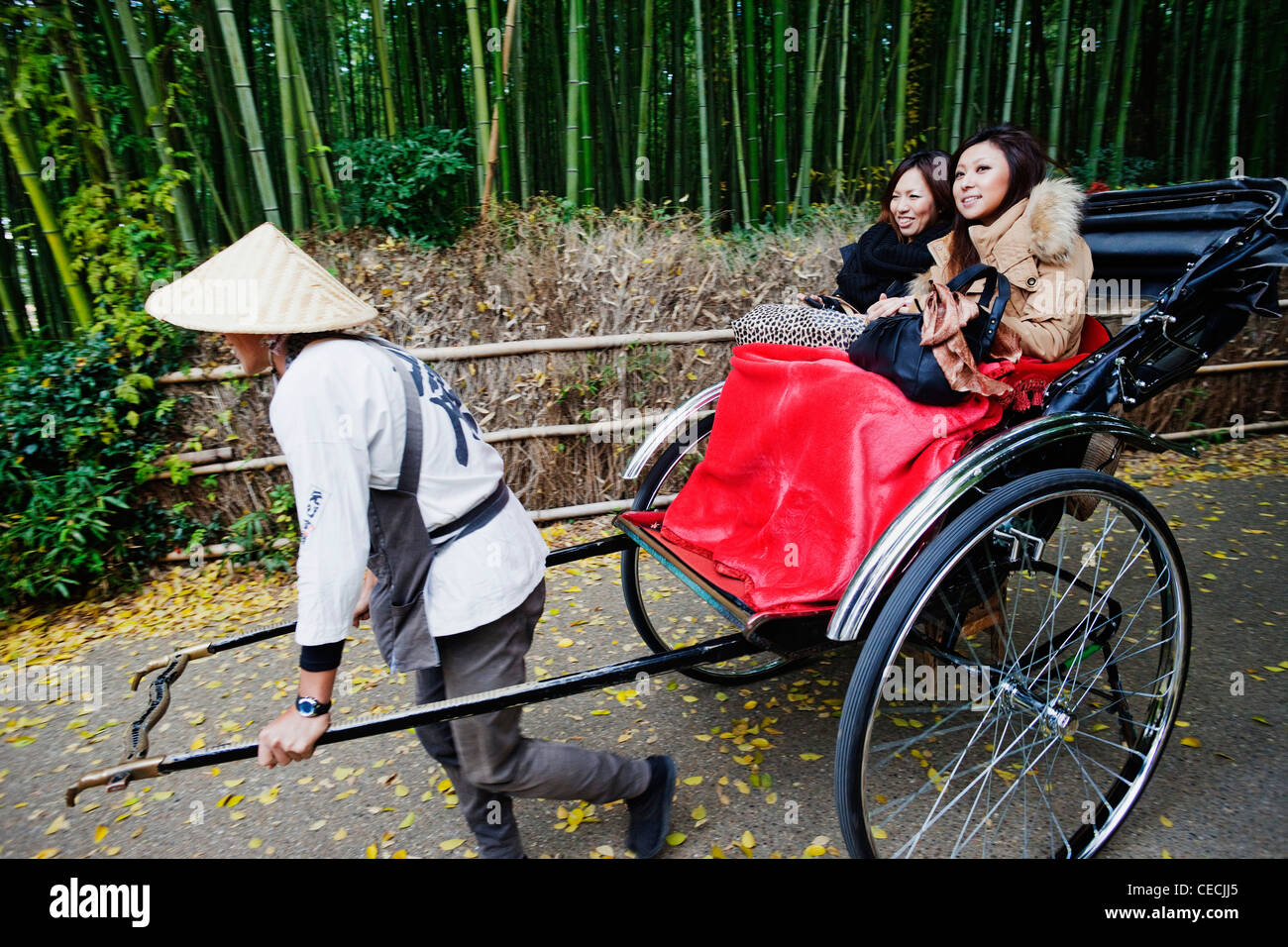 Two women riding in a rickshaw, Japan Stock Photo - Alamy