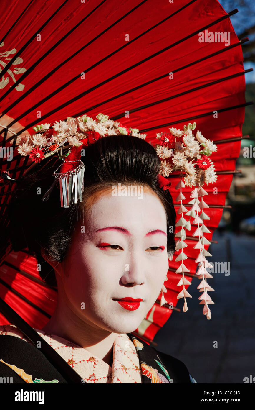 Head shot of Geisha with red umbrella Stock Photo - Alamy