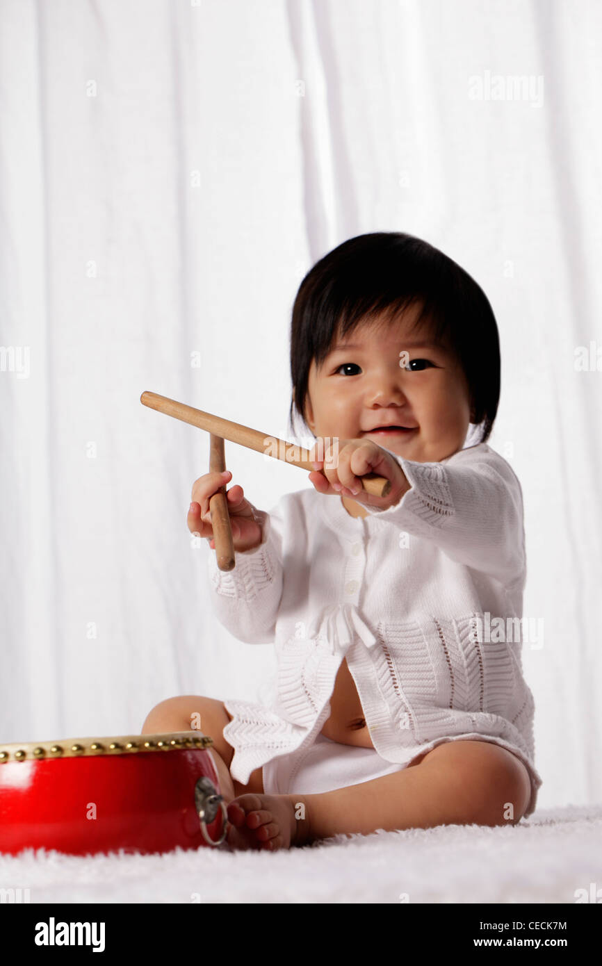 Chinese baby with red drum holding drum sticks Stock Photo - Alamy