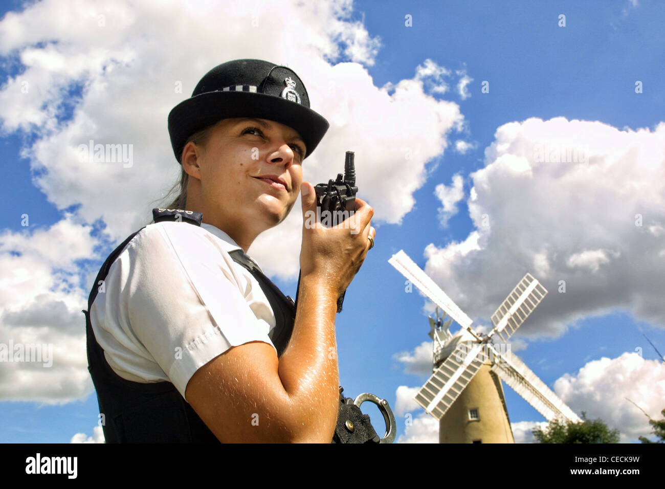 Police officer on her radio whilst on patrol in rural Suffolk, UK Stock ...