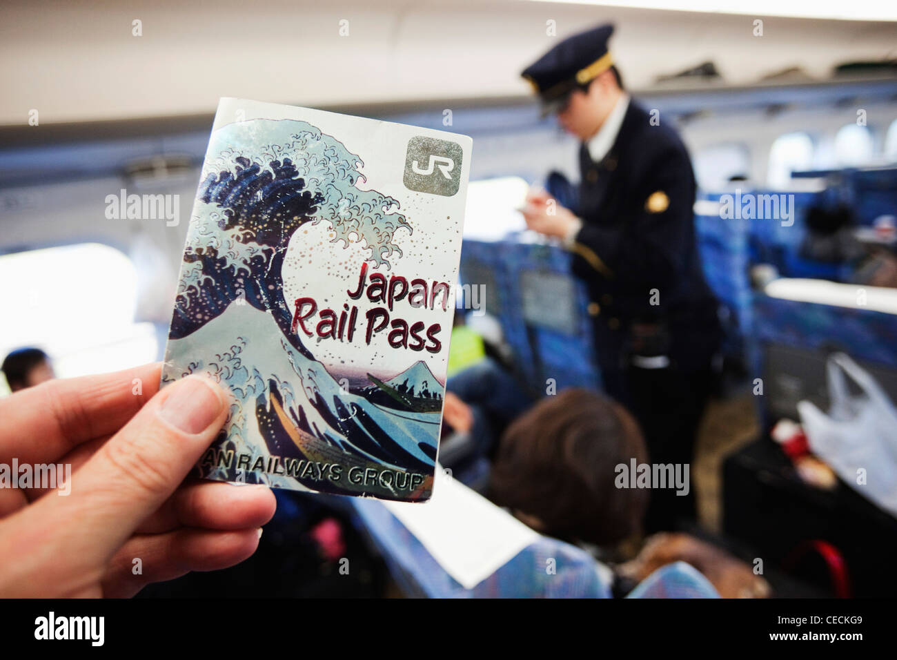 Close up of hand holding a Rail Pass inside the bullet train with the ...