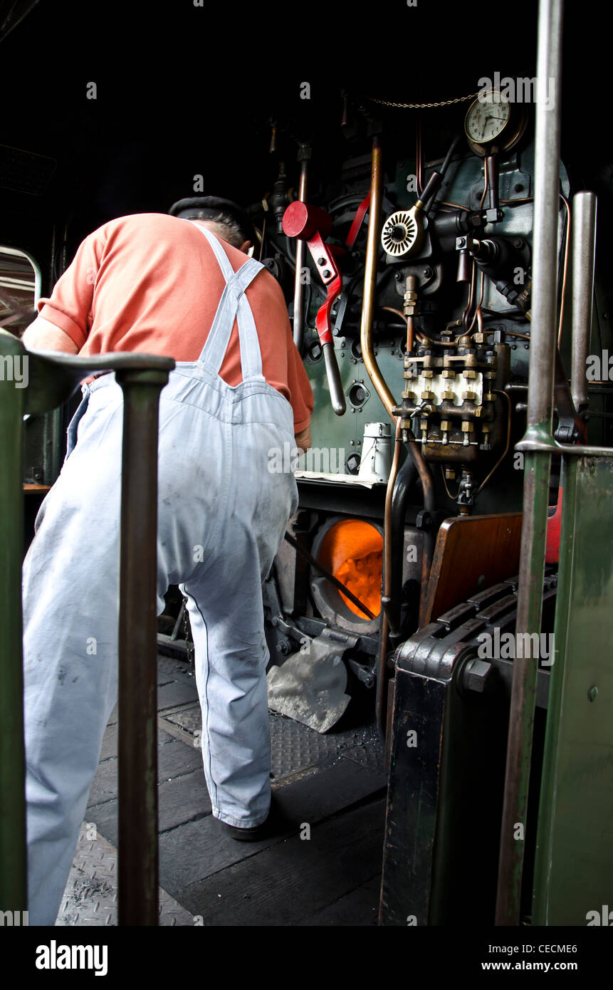 Stoking the fire of a steam locomotive on the Llangollen Railway, North ...