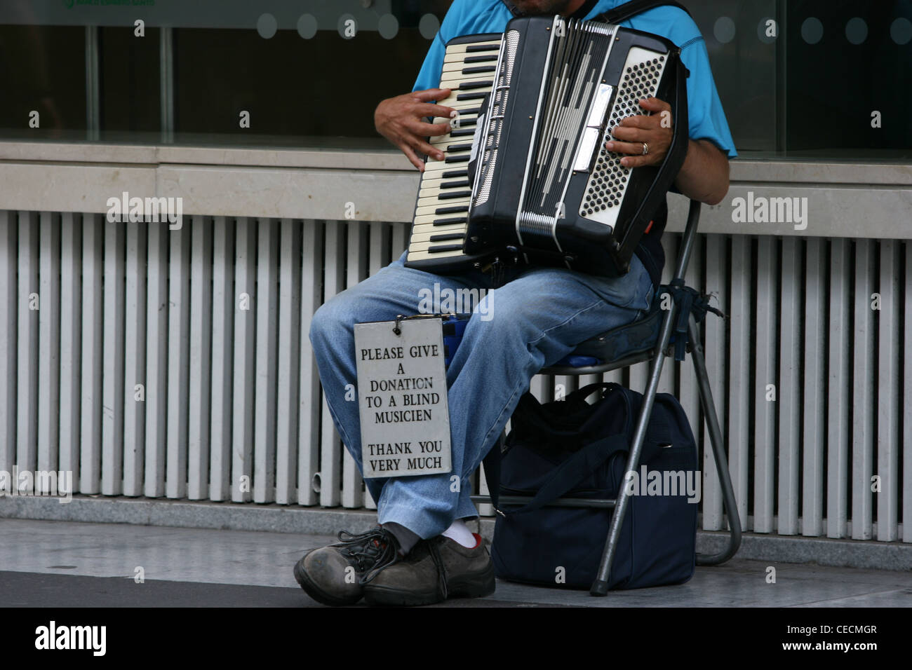 Homeless man playing the accordion Stock Photo - Alamy
