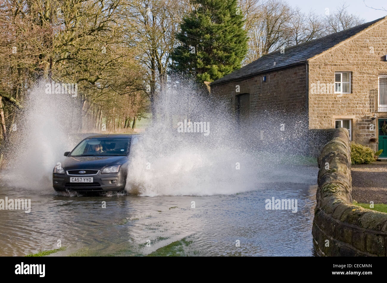 Flooding - Woman driving black car & splashing through deep flood water ...