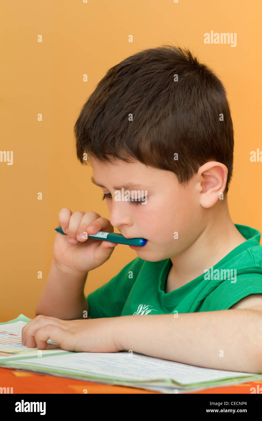boy thinking on homework from school in workbook Stock Photo - Alamy