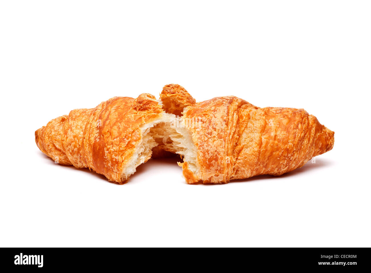 Single French croissant broken open on white background Stock Photo - Alamy