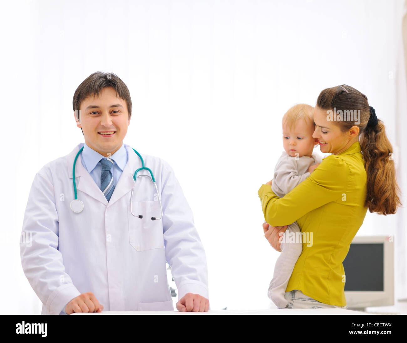 Portrait of pediatric doctor and mother with baby on examination Stock ...