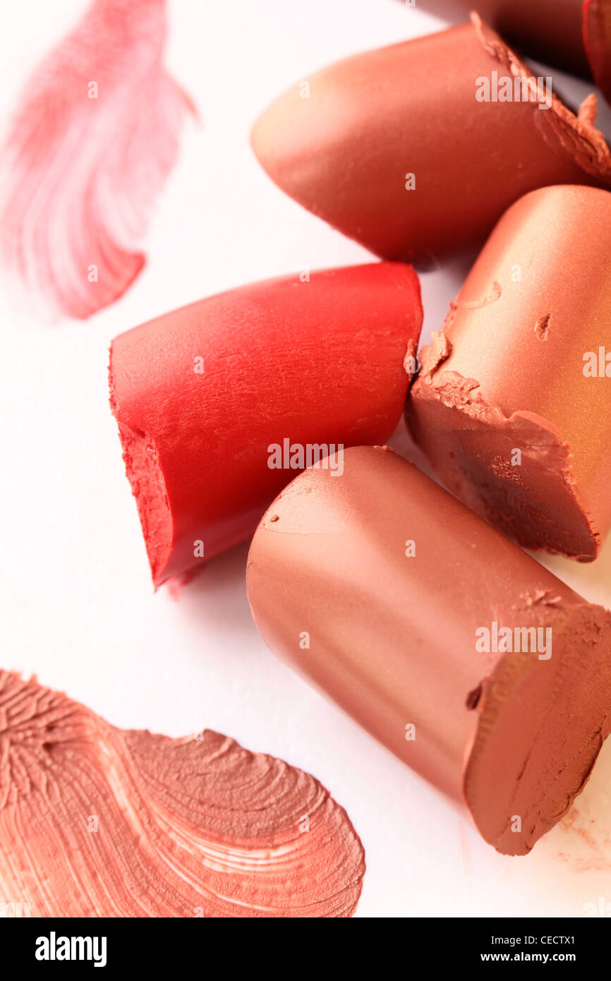 Multi-colored scraps of lipstick on a white background for a make-up ...