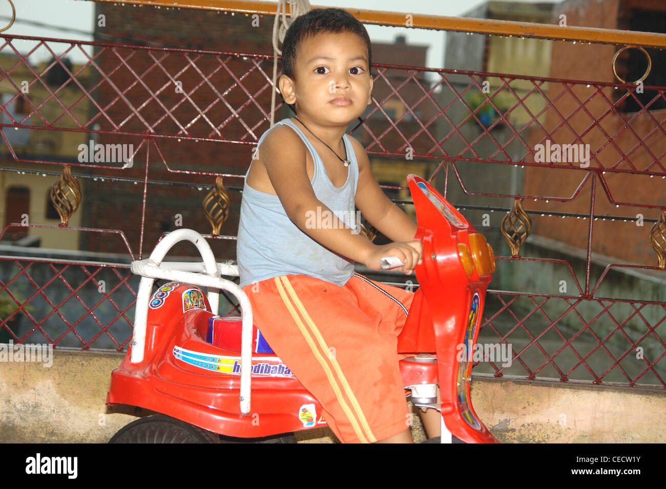 Kid riding tricycle Stock Photo - Alamy