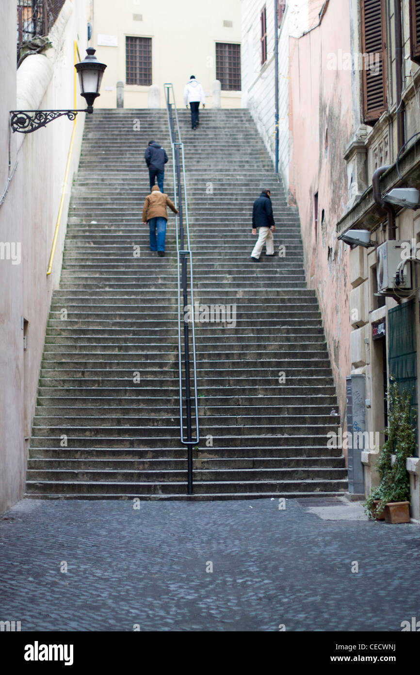 Four men climbing a very steep Stone Staircase in Roma Italy Stock ...
