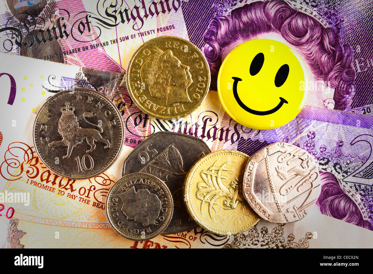 Smiley face badge with British coins and cash Stock Photo - Alamy