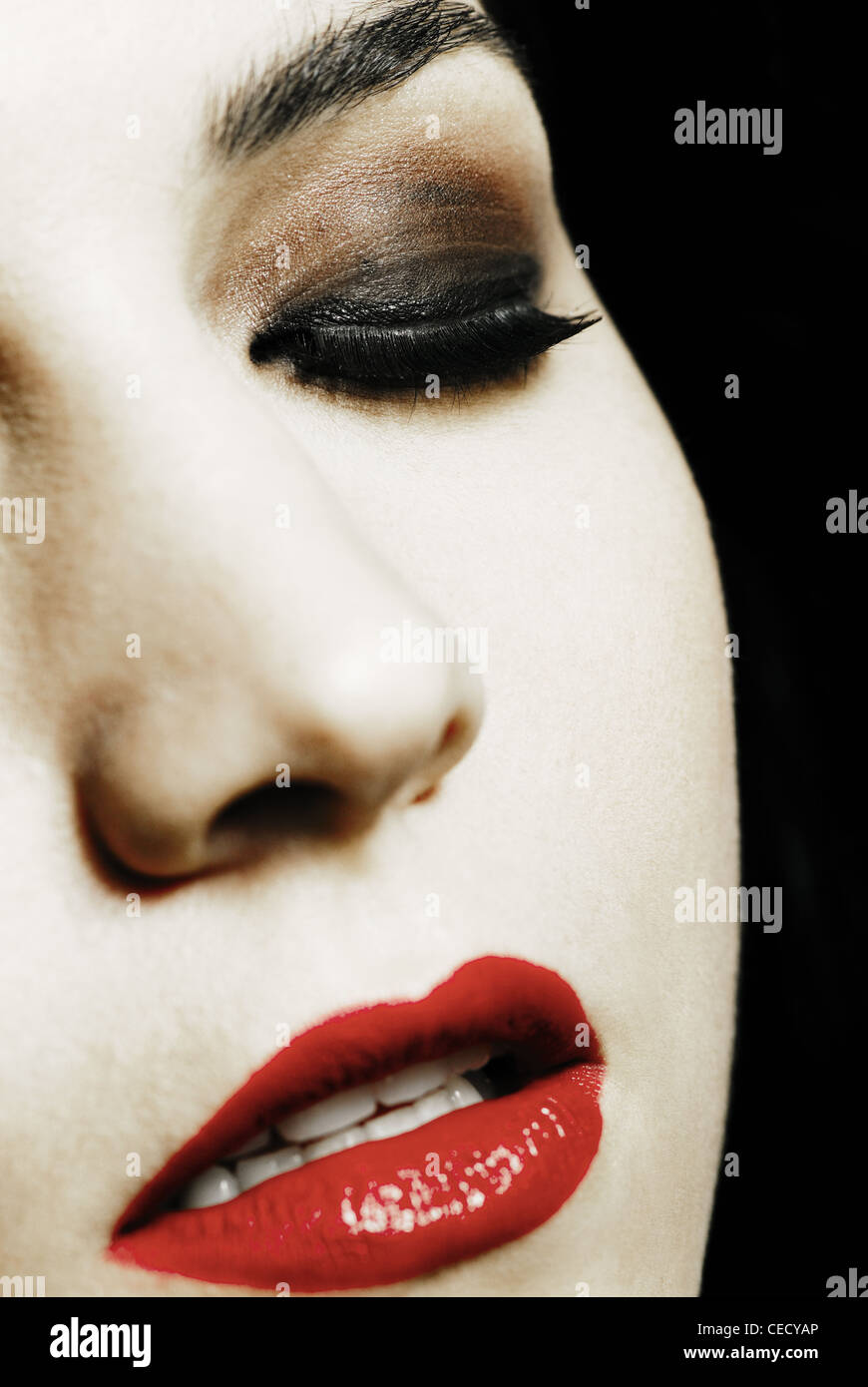 Makeup closeup image of a young woman with false eyelashes and red ...