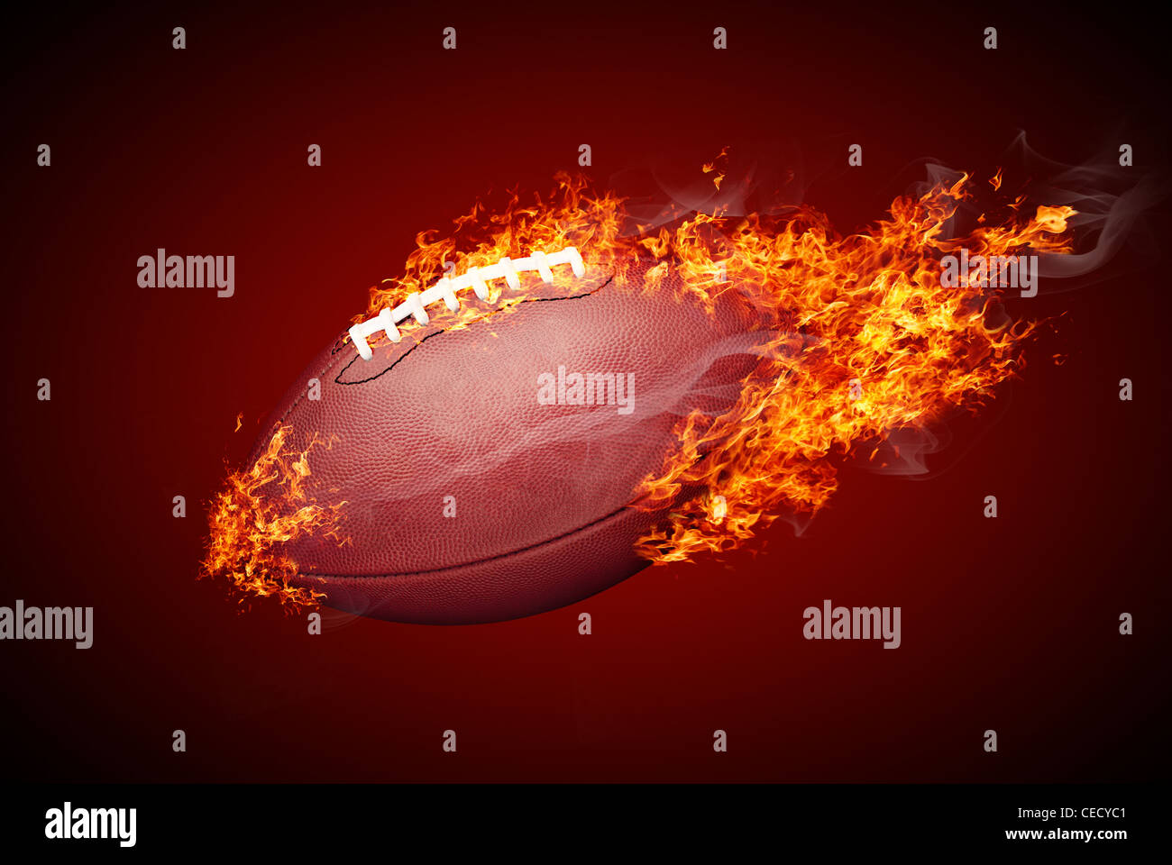 American football ball in fire isolated on dark red background Stock ...