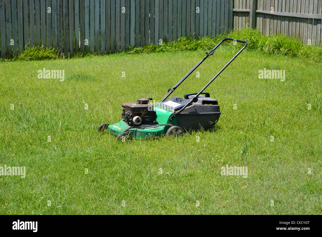 Lawn mower in long grass Stock Photo - Alamy