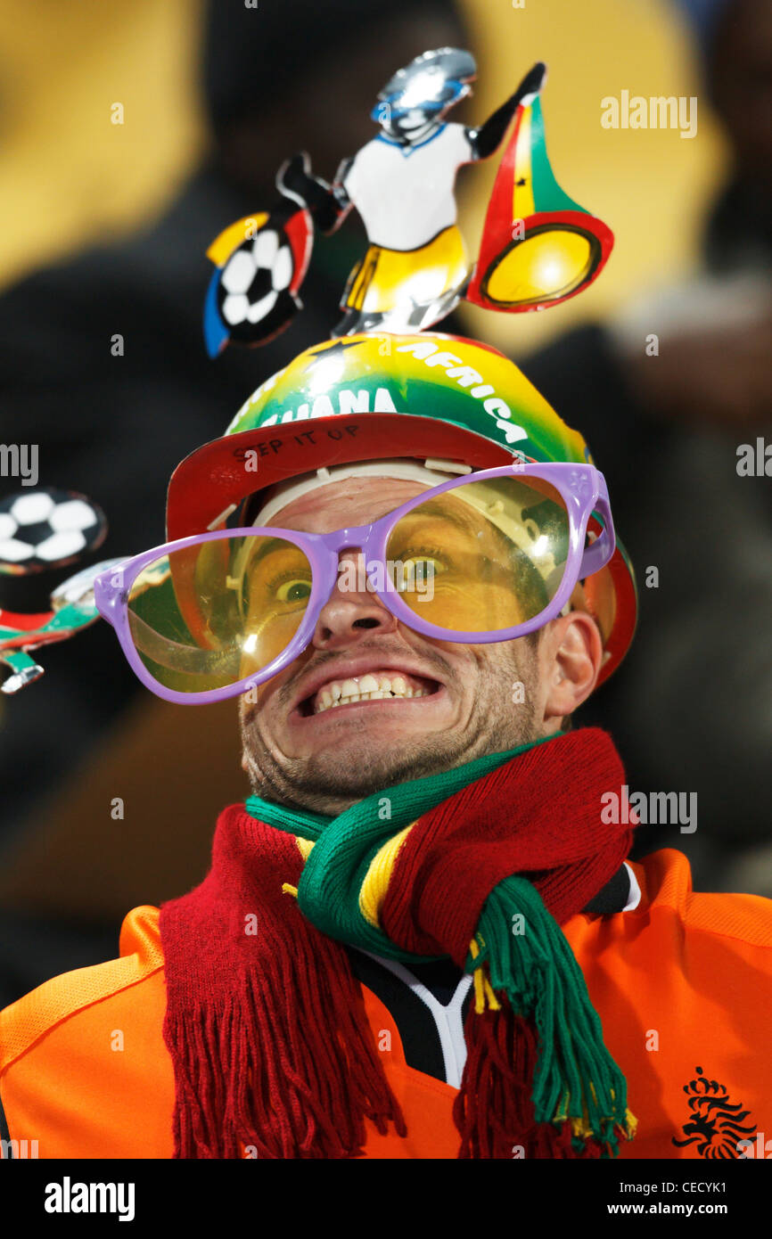 A spectator in the stands makes a face at a 2010 FIFA World Cup round ...