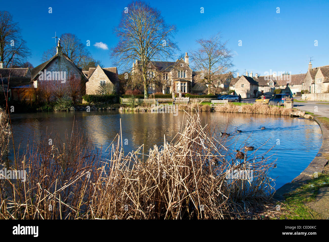 Houses around a typical English village duck pond on the green in ...
