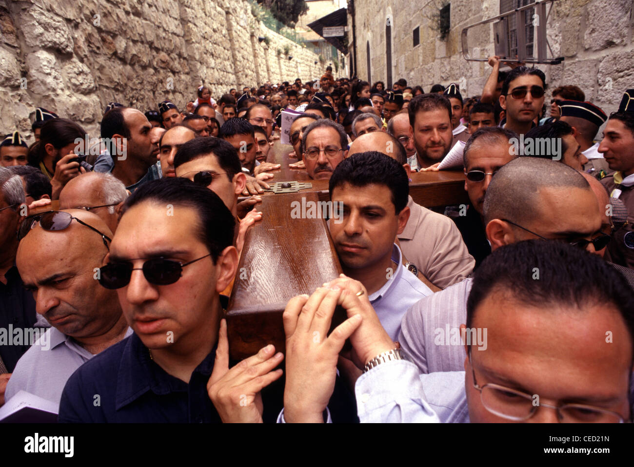 Arab Christian worshipers carrying wooden cross along Via Dolorosa ...